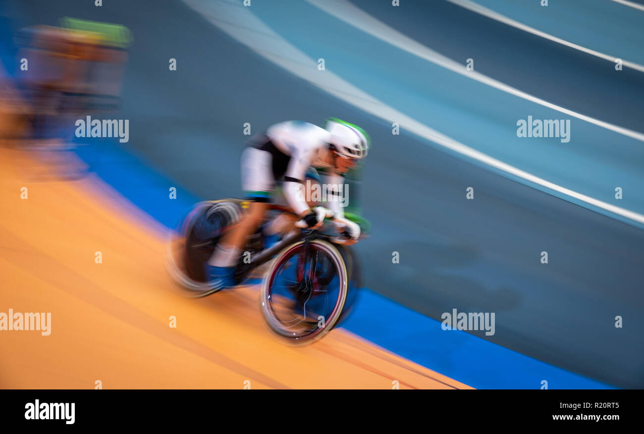 Blurred motion of fast cyclist competing indoor Stock Photo - Alamy