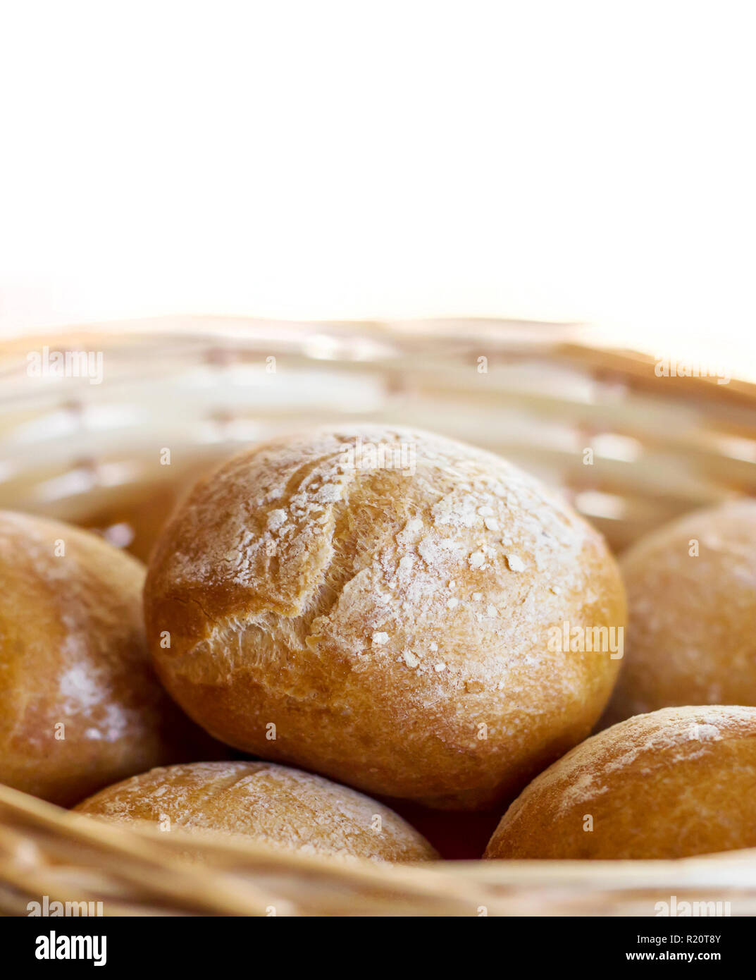 Bread and buns inside basket. Fresh bakery products on table. Shallow ...