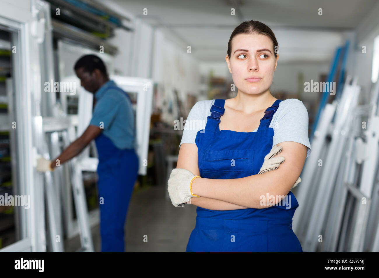 Portrait of sad woman worker who is standing in the pvc workshop Stock ...