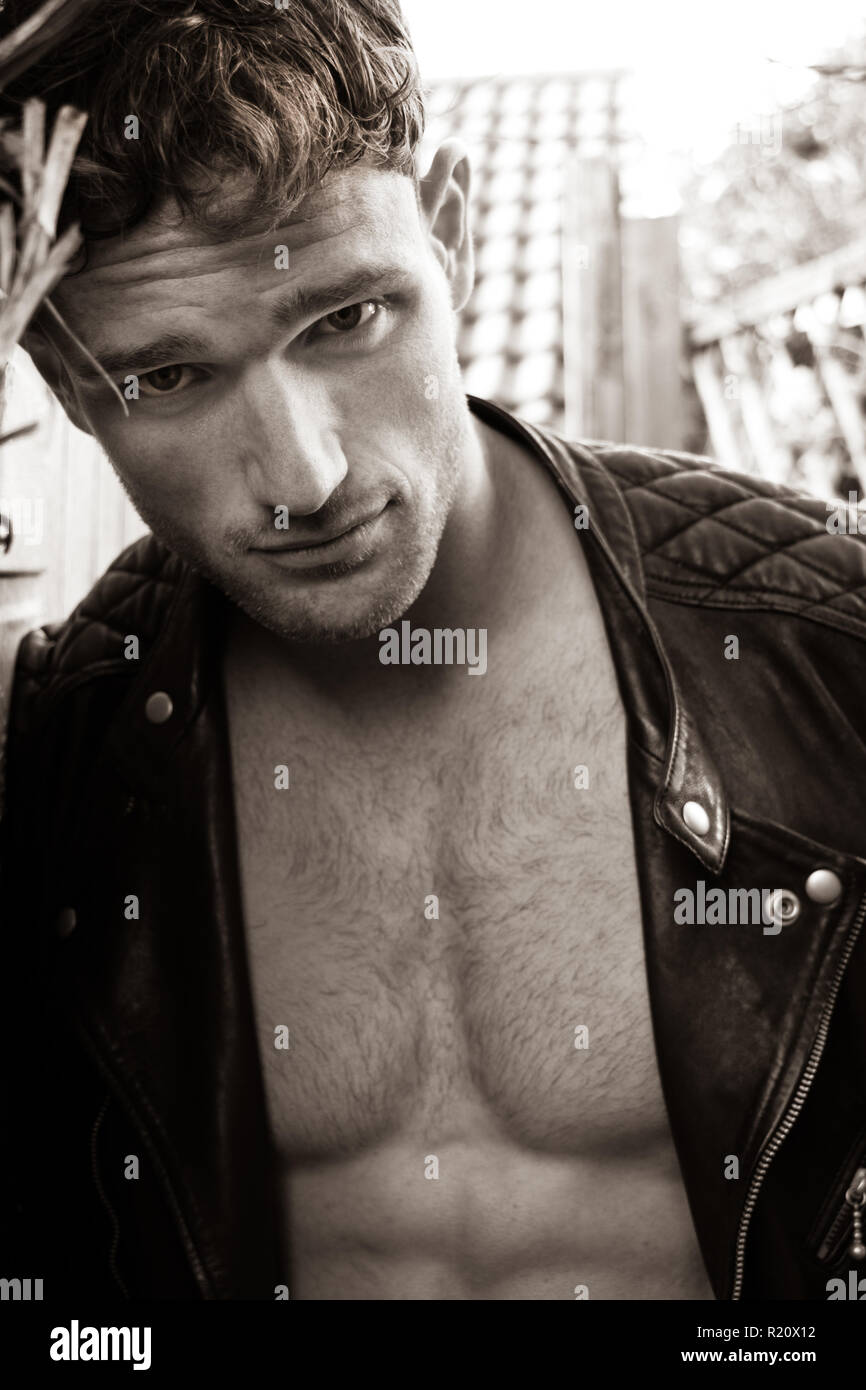 Good looking man with sixpack abs and leather jacket smoking a ...