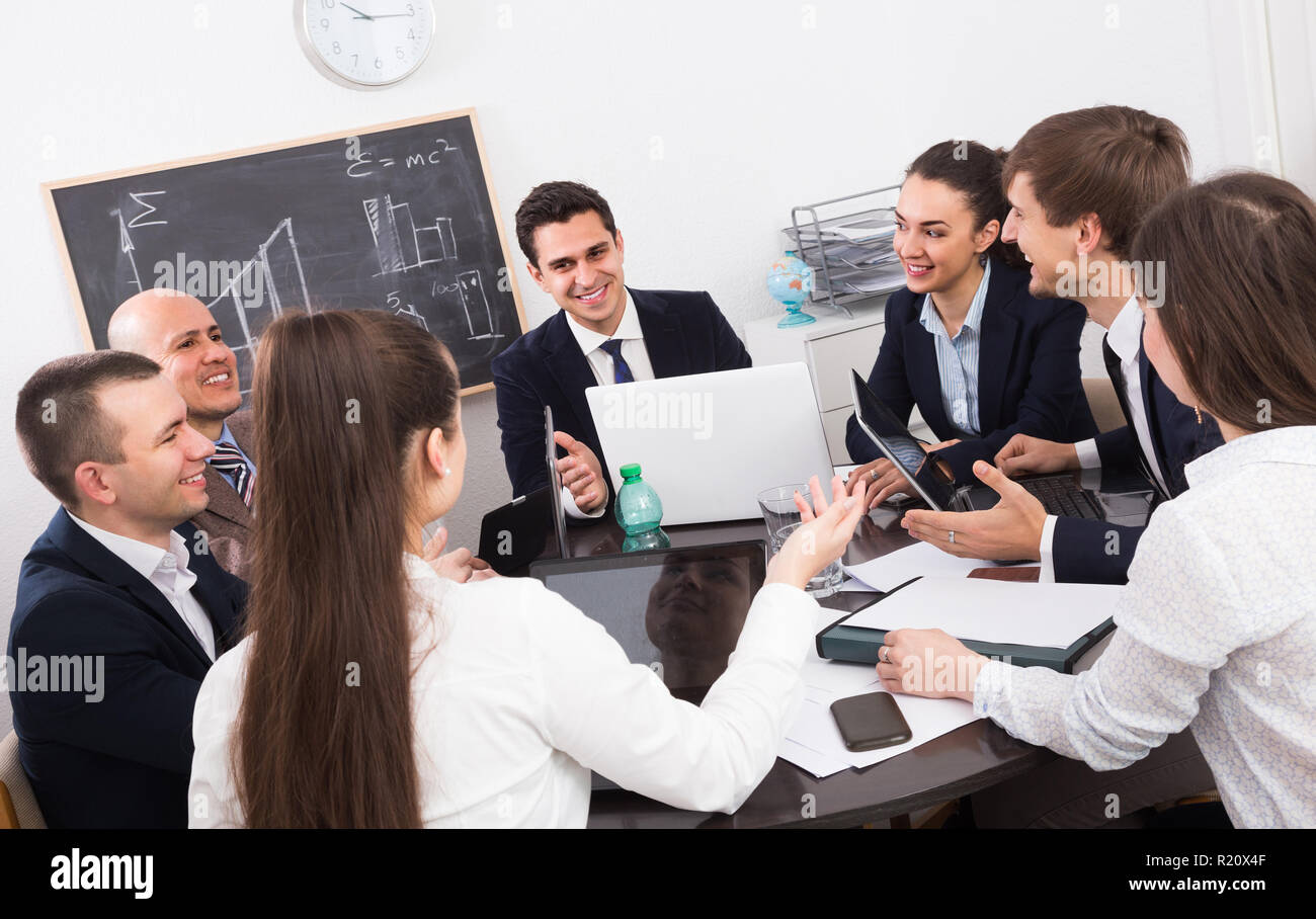 Positive team discussing business project at corporate meeting in ...