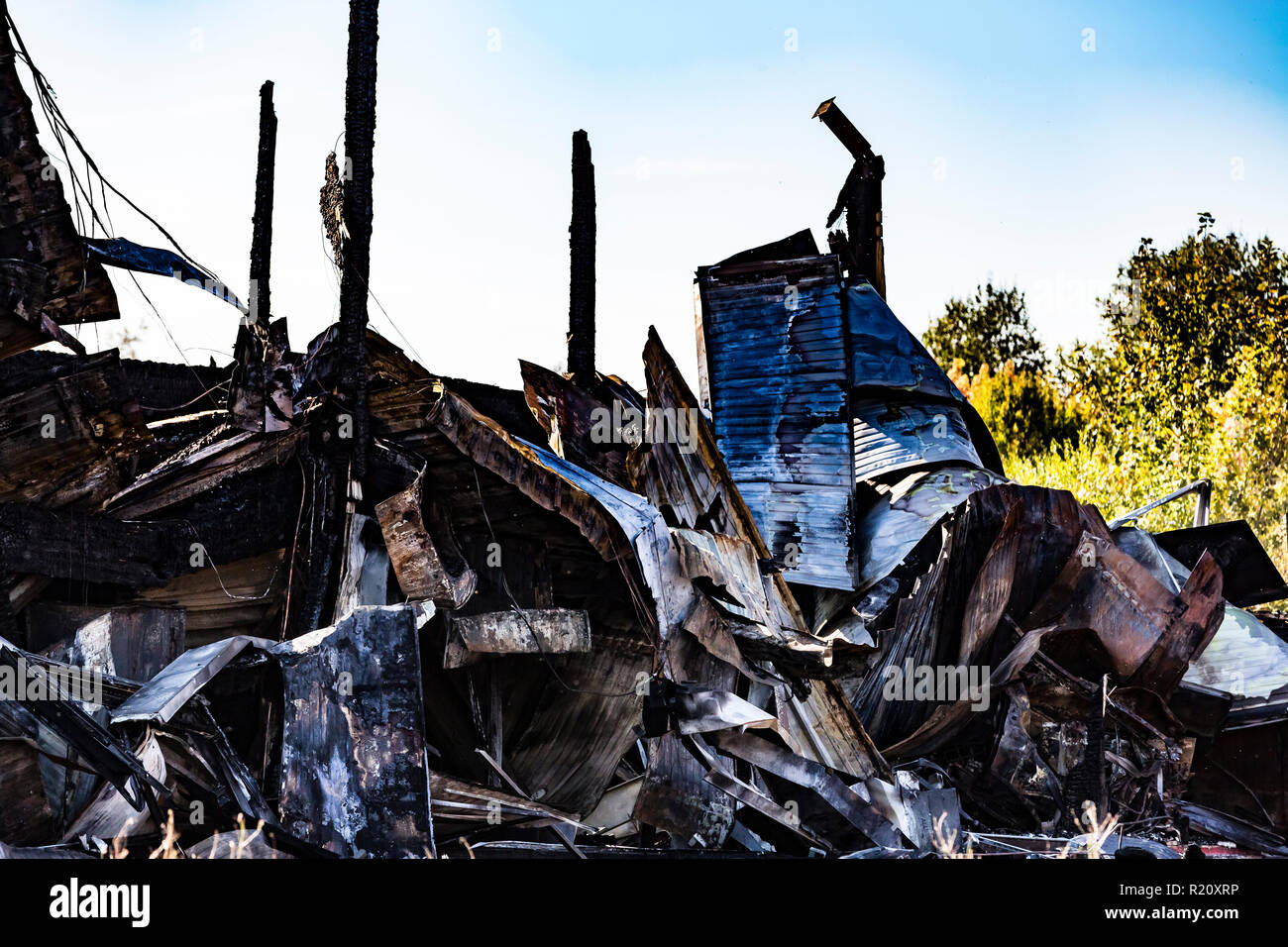 Damaged industry supermarket after arson fire with burn debris of ...