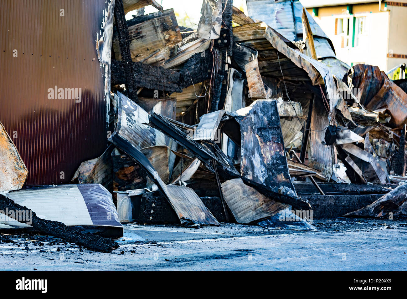 Damaged industry supermarket after arson fire with burn debris of ...
