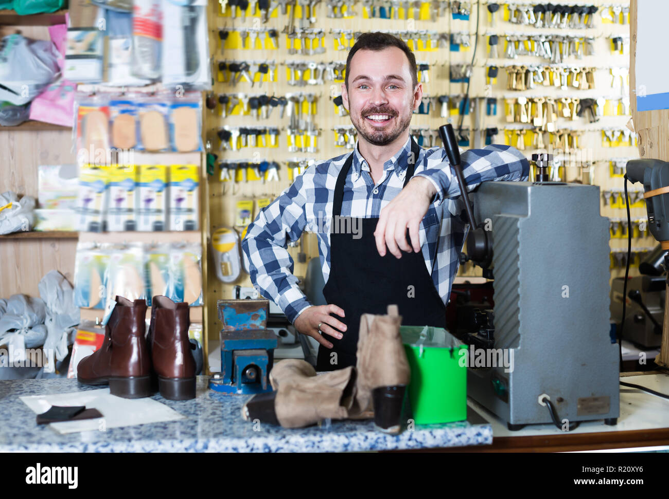 Male worker showing his tools for making keys in workshop Stock Photo ...