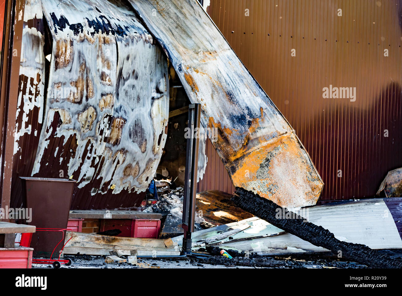 Damaged industry supermarket after arson fire with burn debris of ...