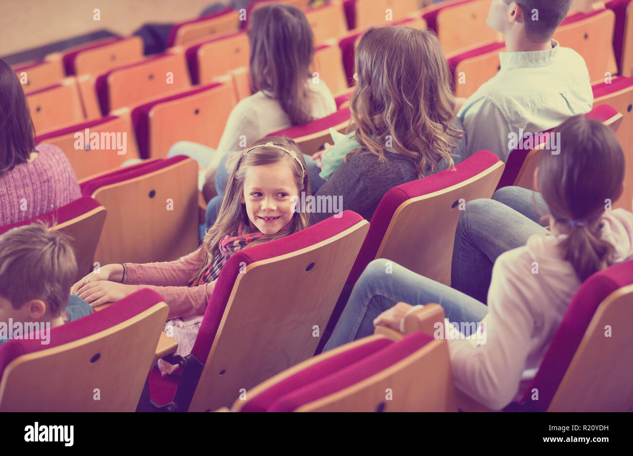 Female child looking away from screen in cinema house Stock Photo - Alamy