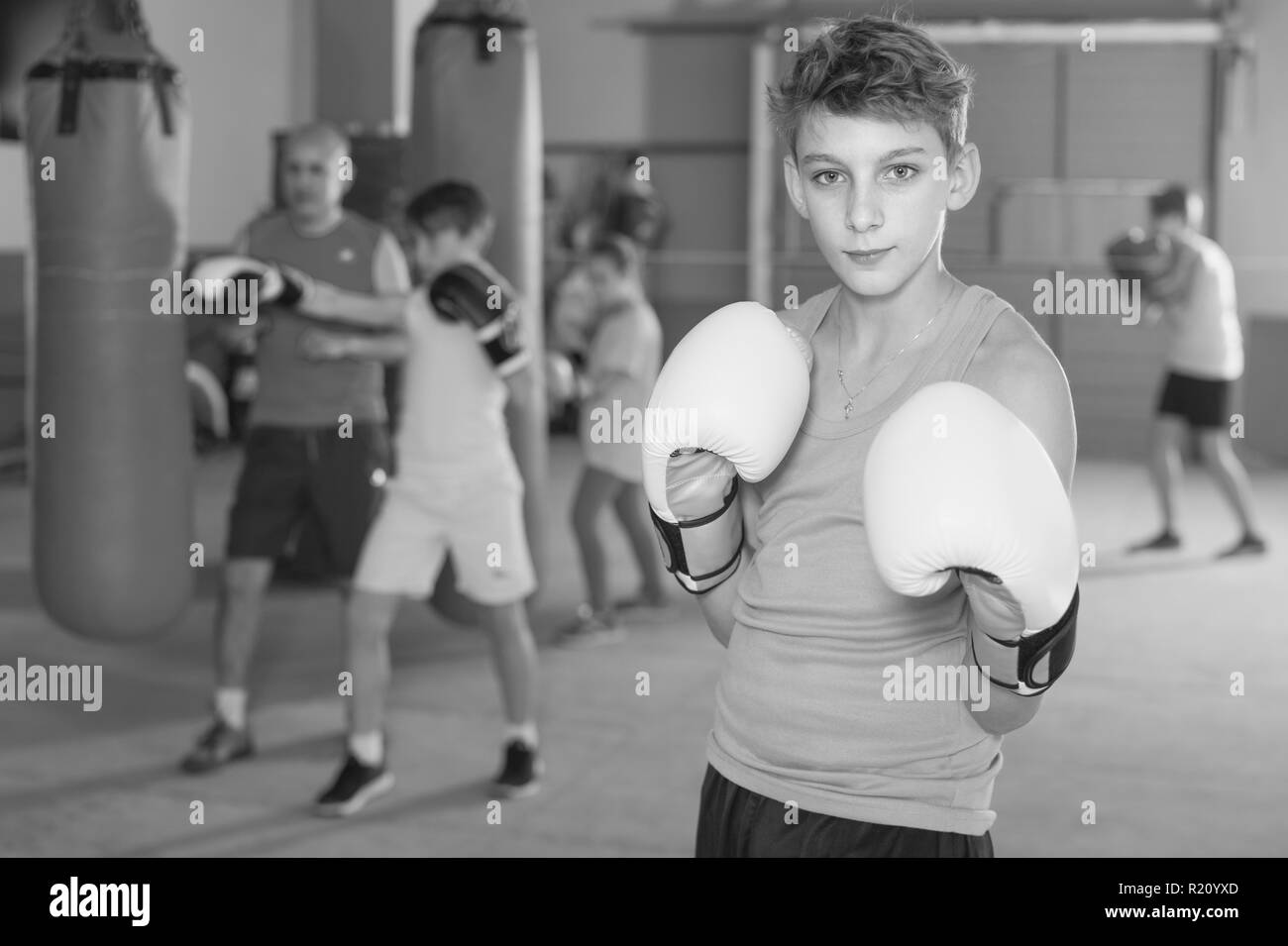 Boy boxer in gloves posing during boxing practicing at gym Stock Photo ...