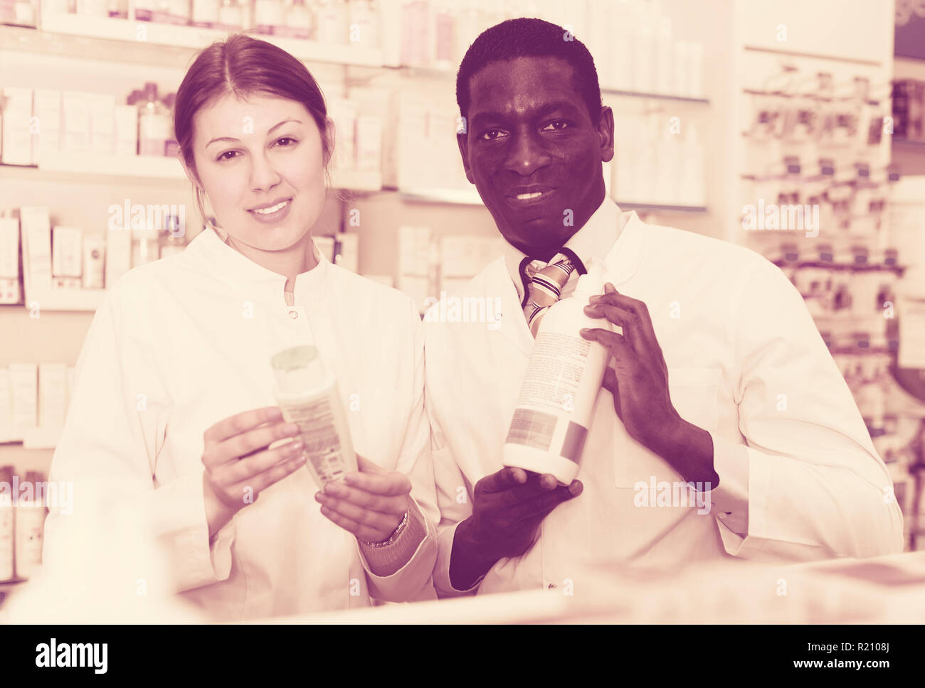 Portrait two experienced pharmacists standing in interior of modern ...