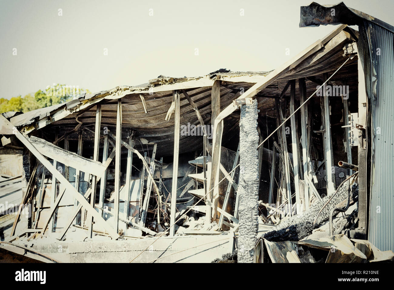 Damaged industry supermarket after arson fire with burn debris of ...