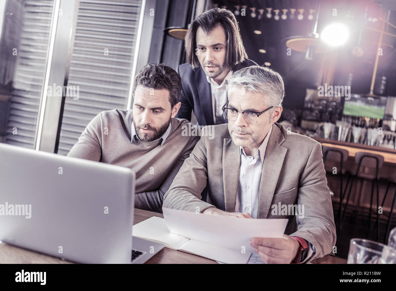 Three colleagues working together at business plan Stock Photo - Alamy