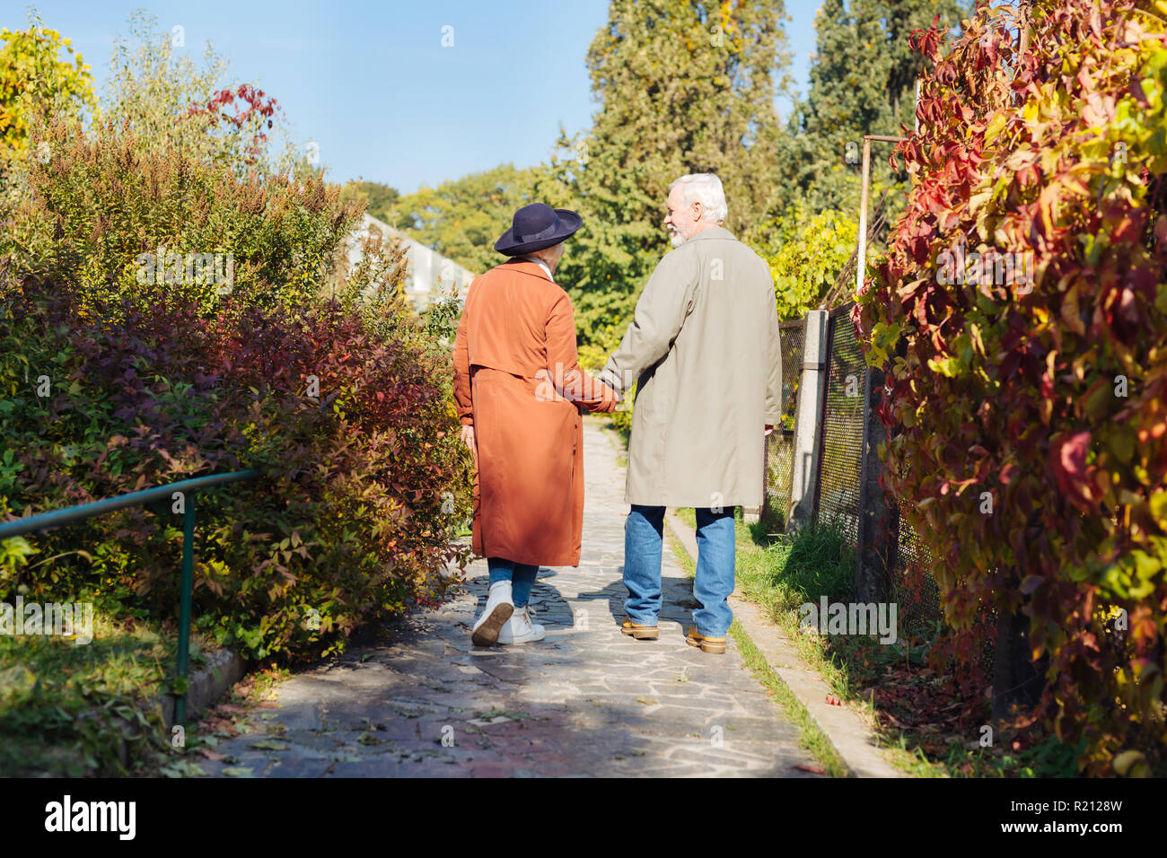 Nice pleasant aged couple going home together Stock Photo - Alamy
