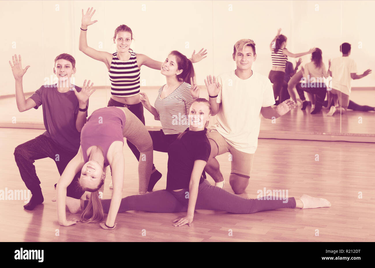 Group of smiling students with teacher posing in dance class Stock ...
