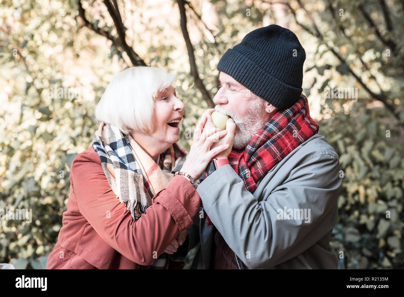 Mature woman biting apple hi-res stock photography and images - Alamy