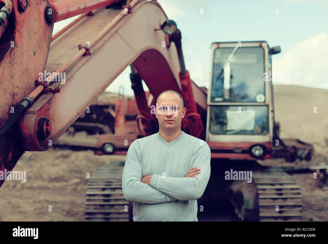 Portrait of tractor operator at sand pit Stock Photo - Alamy