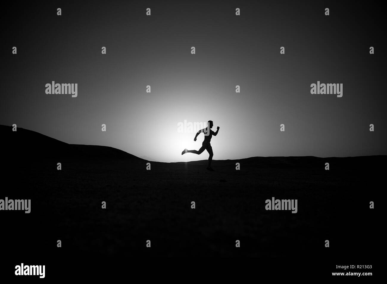 just run. man silhouette, running guy on sunset fiery sky background in ...