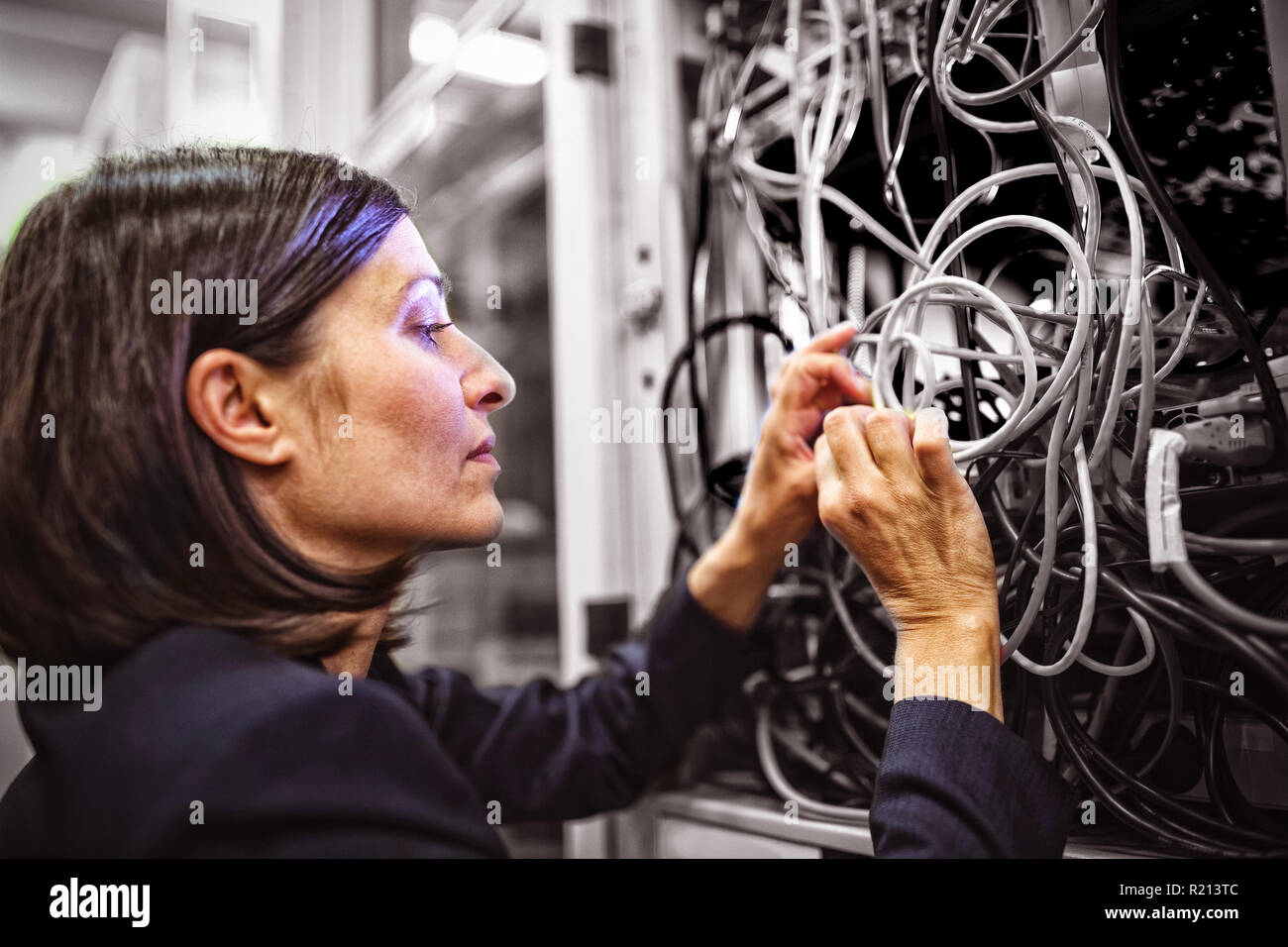 Technician fixing cable Stock Photo - Alamy