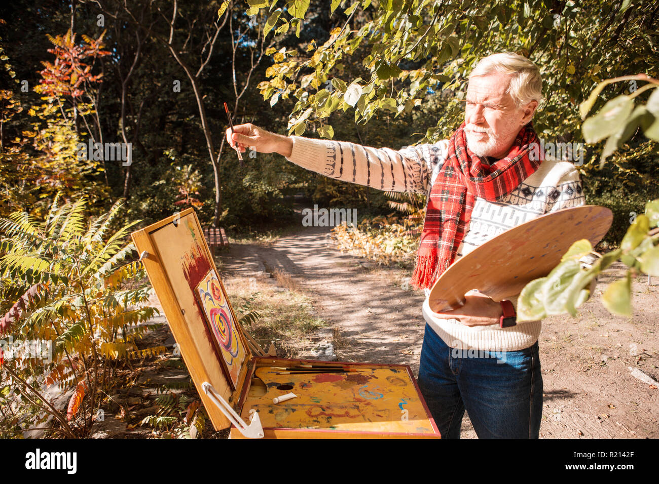 Nice talented artist creating a new painting Stock Photo - Alamy