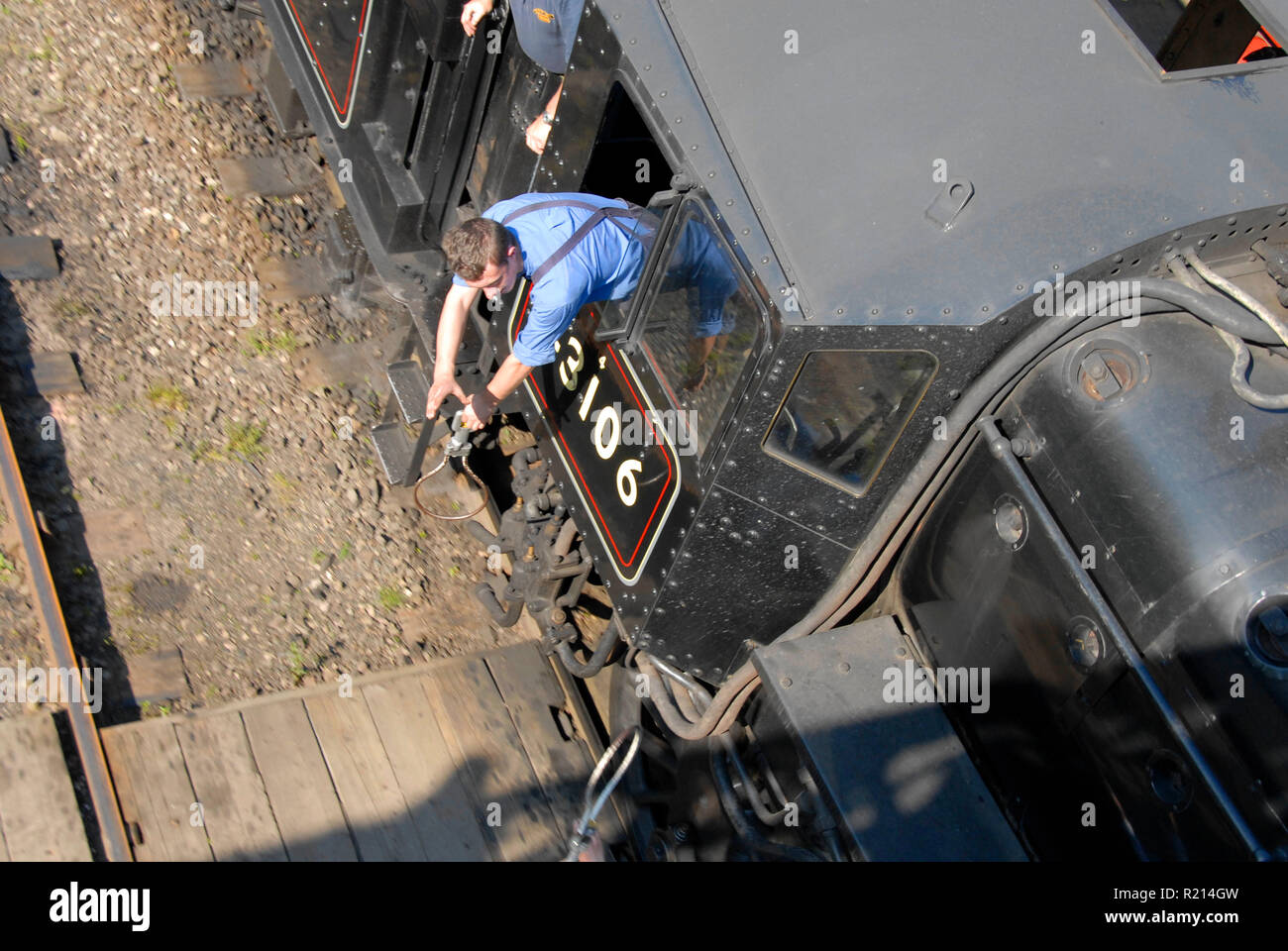 Train driver preparing to exchange tokens before entering section of ...
