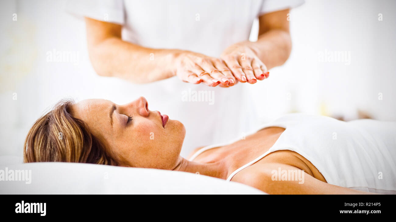 Young woman receiving reiki treatment Stock Photo - Alamy