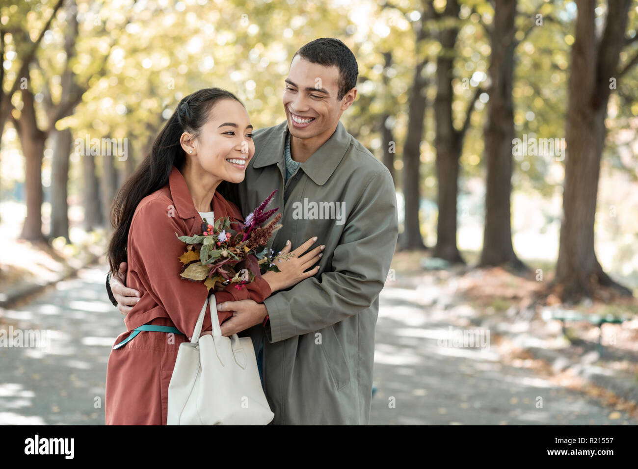 Joyful young people standing close to each other Stock Photo - Alamy