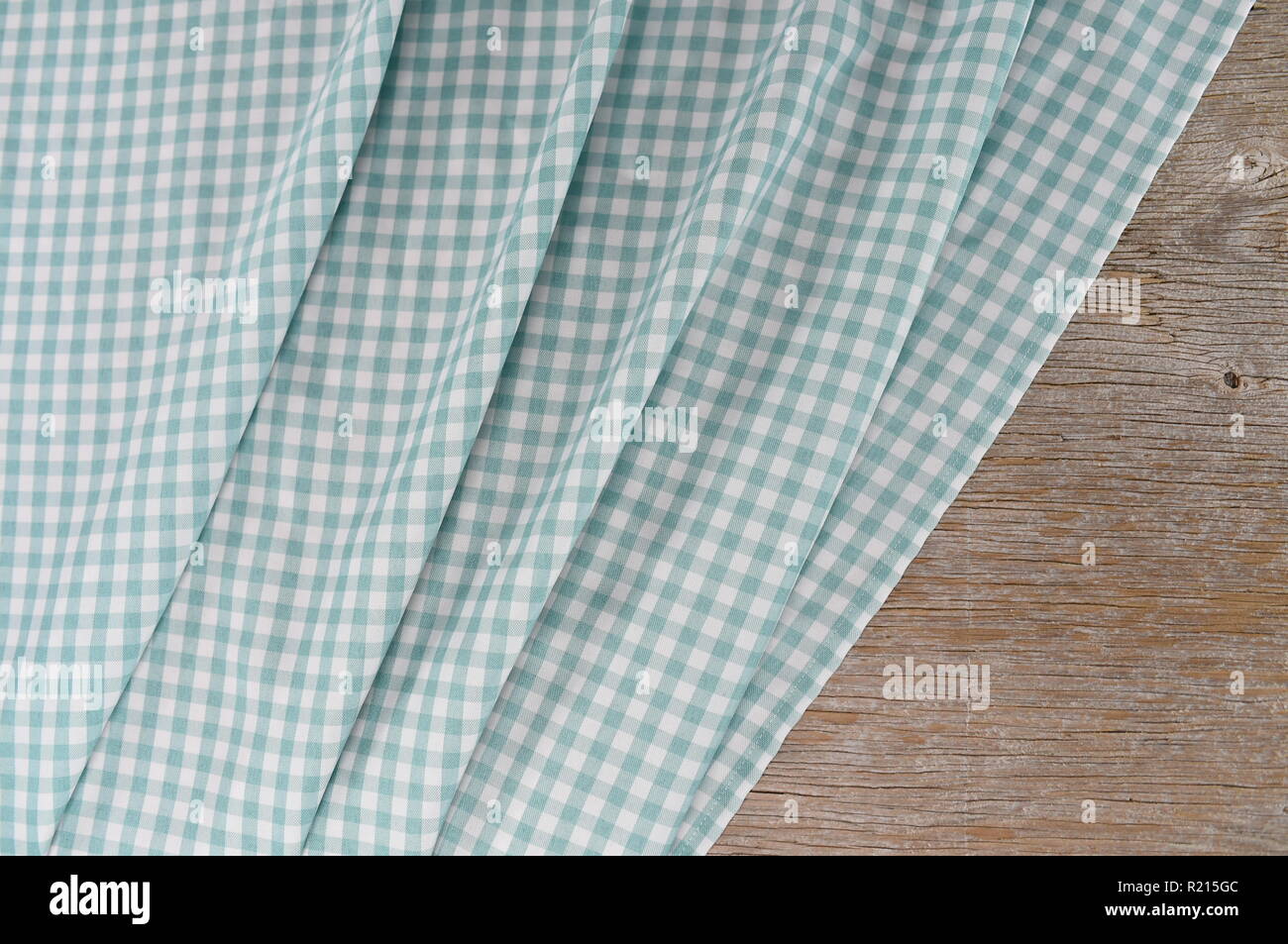 Mint and white is the checkered pattern on a tablecloth. The fabric ...