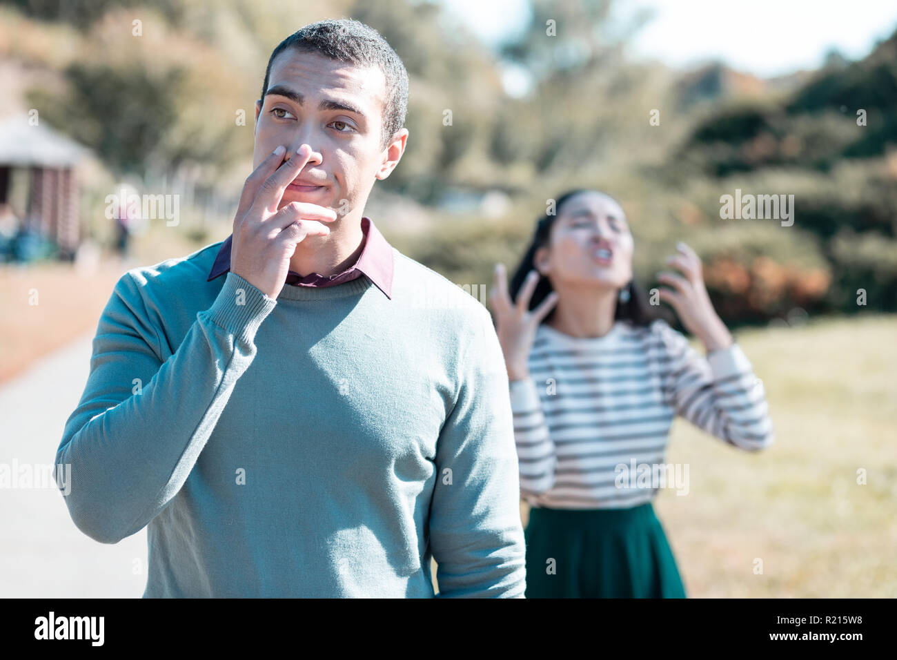 Emotional male person touching his face while hand Stock Photo - Alamy