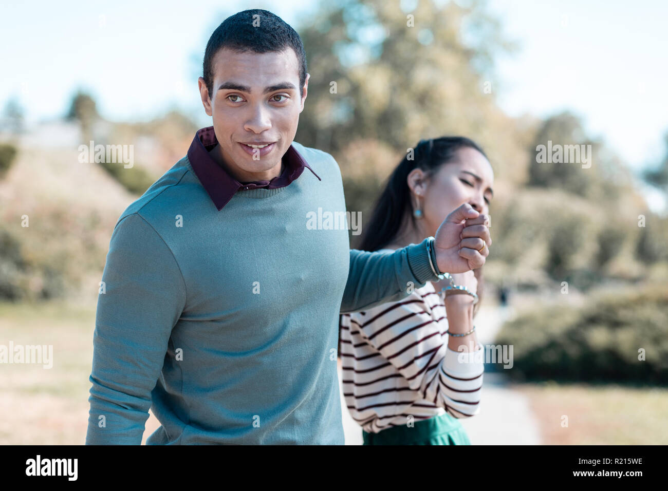 Handsome brunette man walking with his partner Stock Photo - Alamy