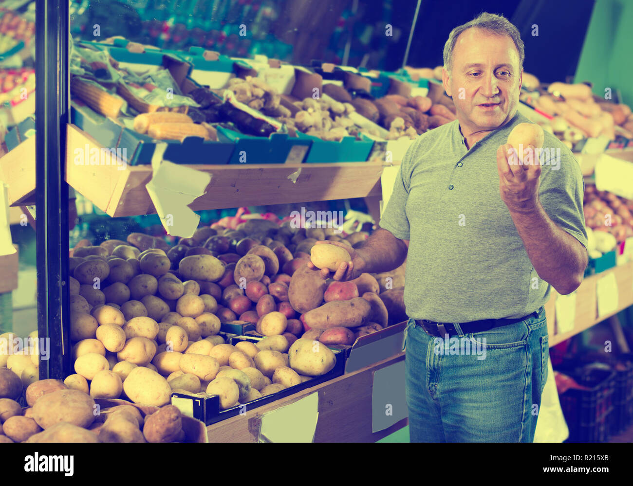 Adult man is choosing potato in the vegetables store Stock Photo - Alamy