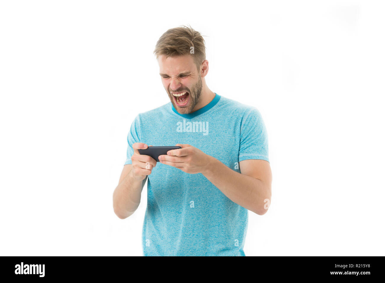 Excited about gaming. Guy play game on smartphone. Guy shouting face ...