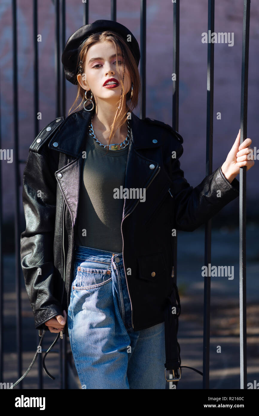 Beautiful model wearing high-waist jeans and black leather jacket Stock ...