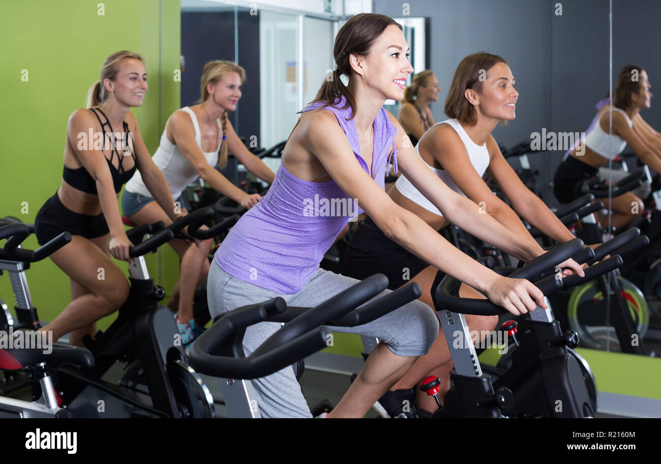 Sporty russian women on cardio training on exercycles in health club ...