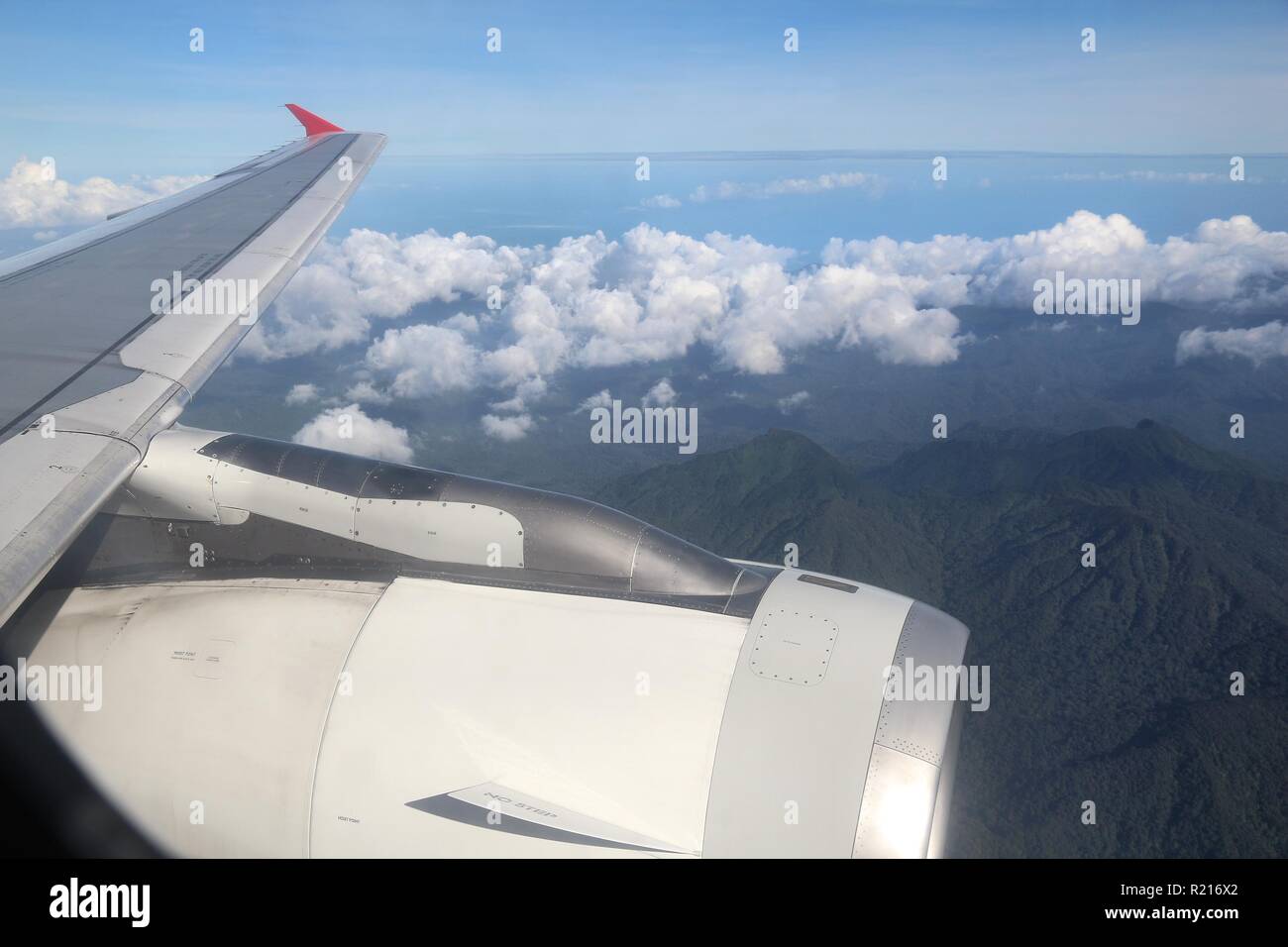 Wing view from passenger aircraft - mountains of Palawan island ...