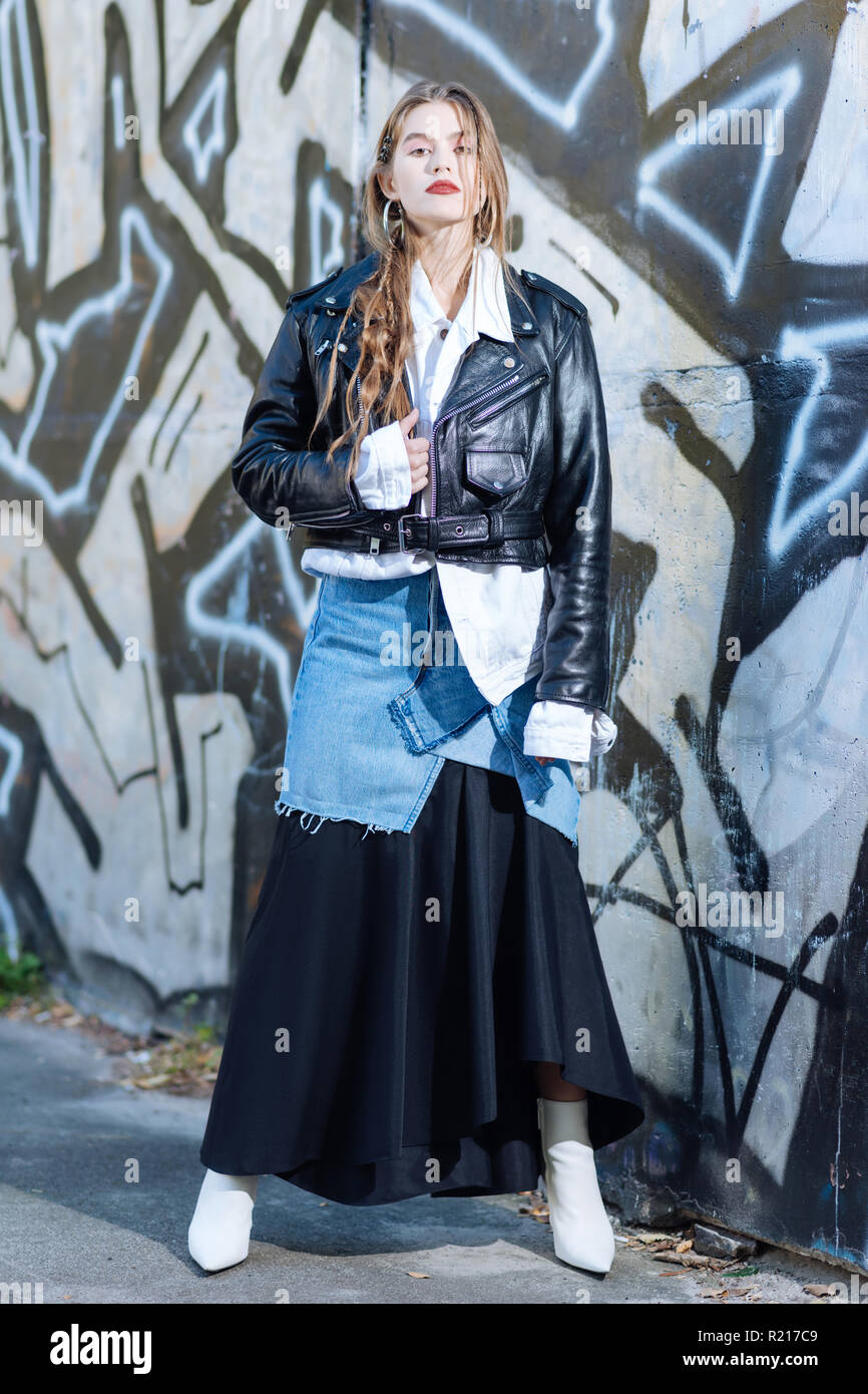Dark-haired young model wearing white shirt and high-heeled boots Stock ...