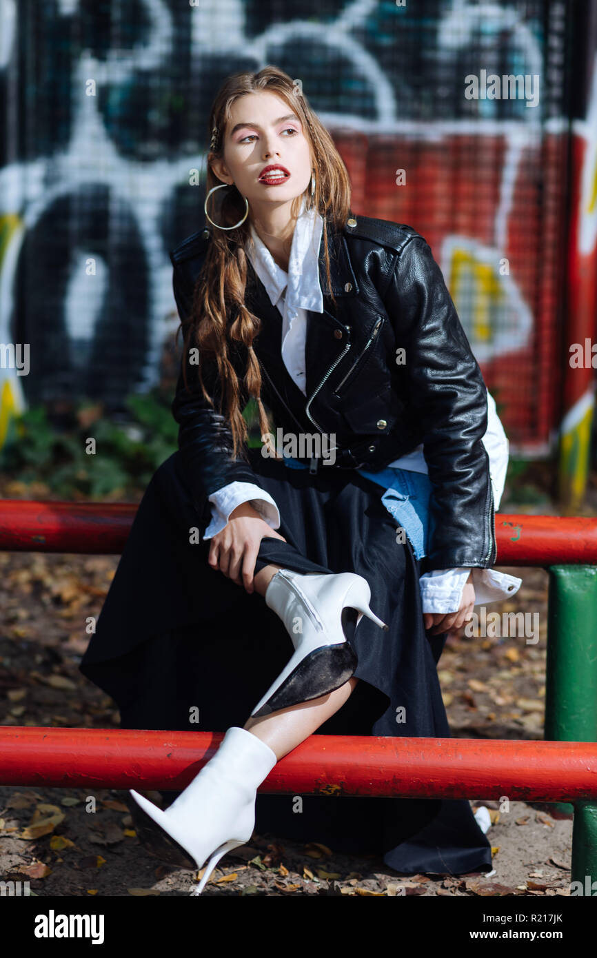 Stylish trendy fashionable model wearing long skirt posing at the ...