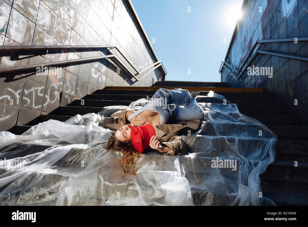 Top view of actress wearing jeans and red beret acting in music video ...