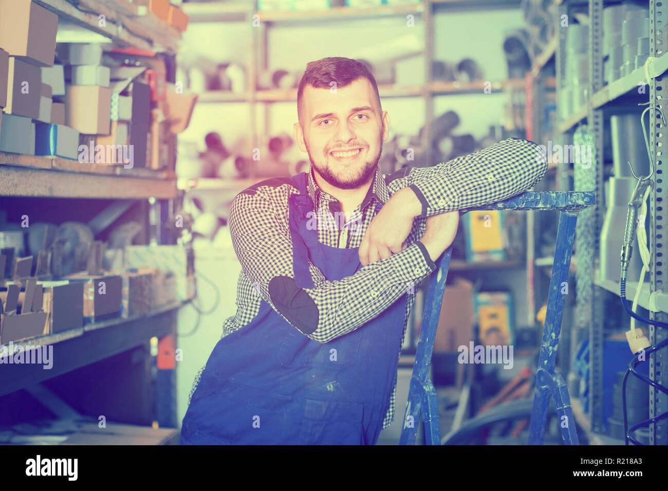 Male worker displaying his workplace at workshop Stock Photo - Alamy