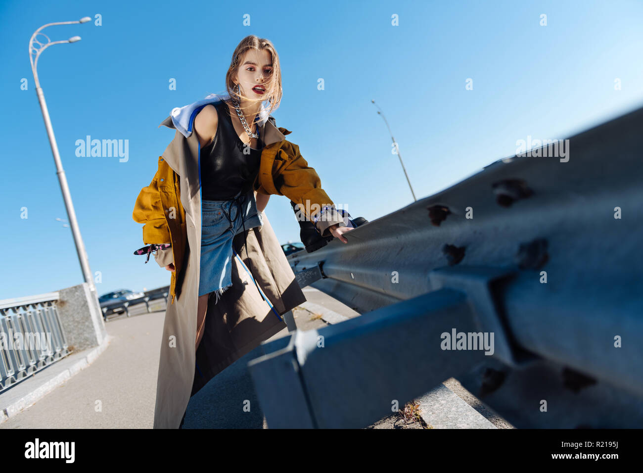 Low angle of young appealing photo model posing promoting clothes Stock ...