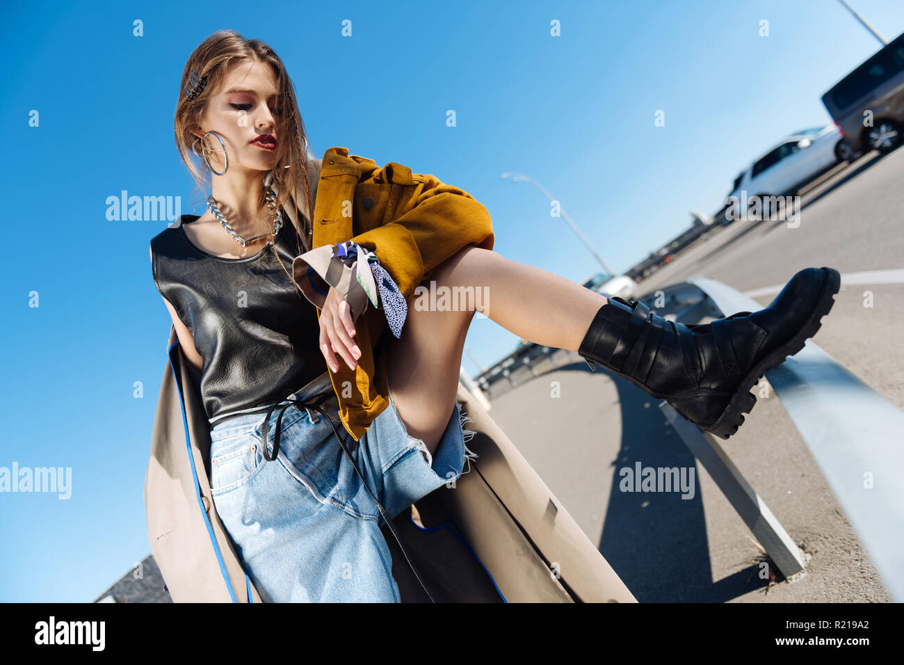 Young model working for famous magazine posing in denim shorts Stock ...