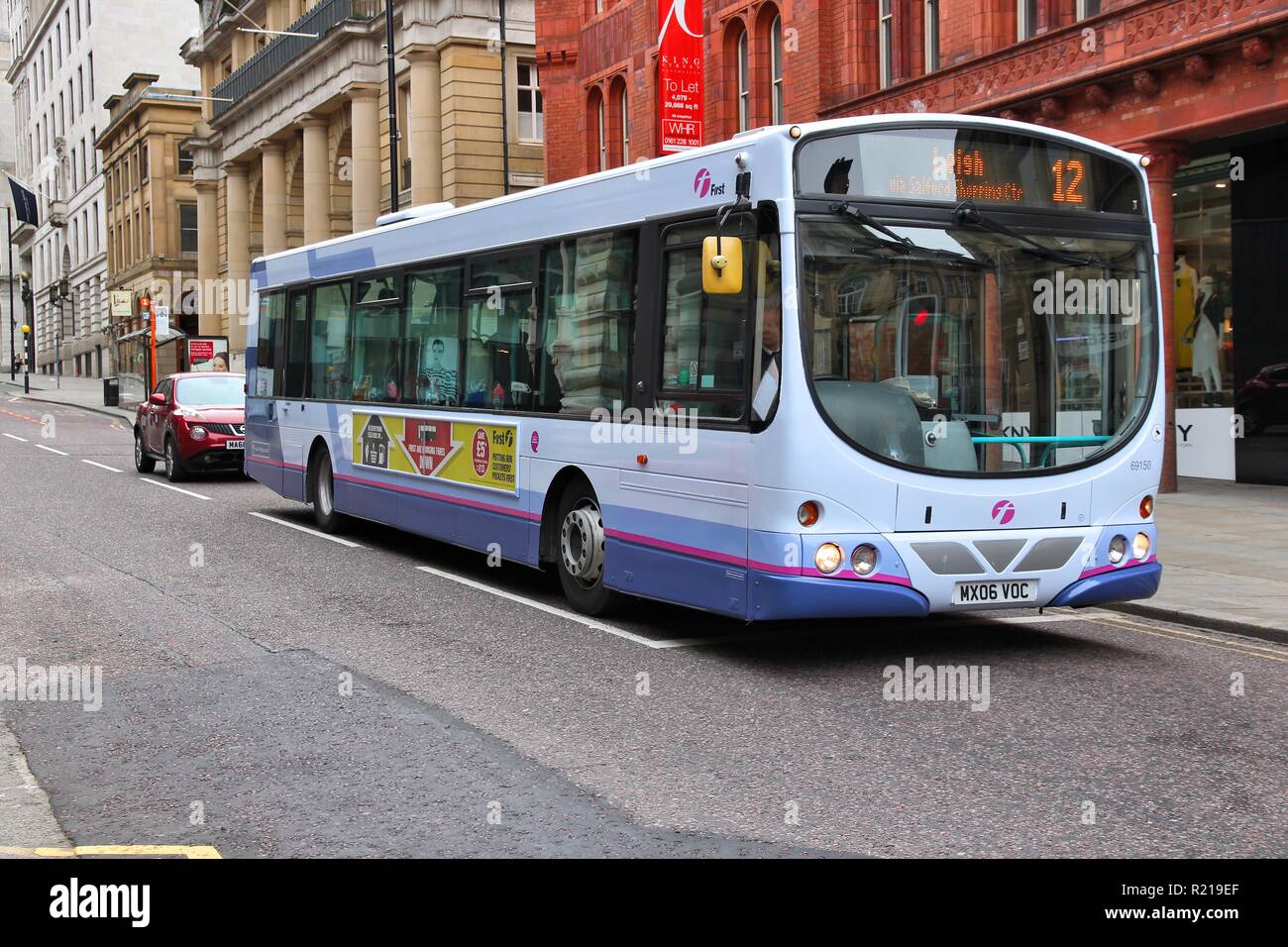 MANCHESTER, UK - APRIL 21, 2013: People ride FirstGroup city bus Volvo ...