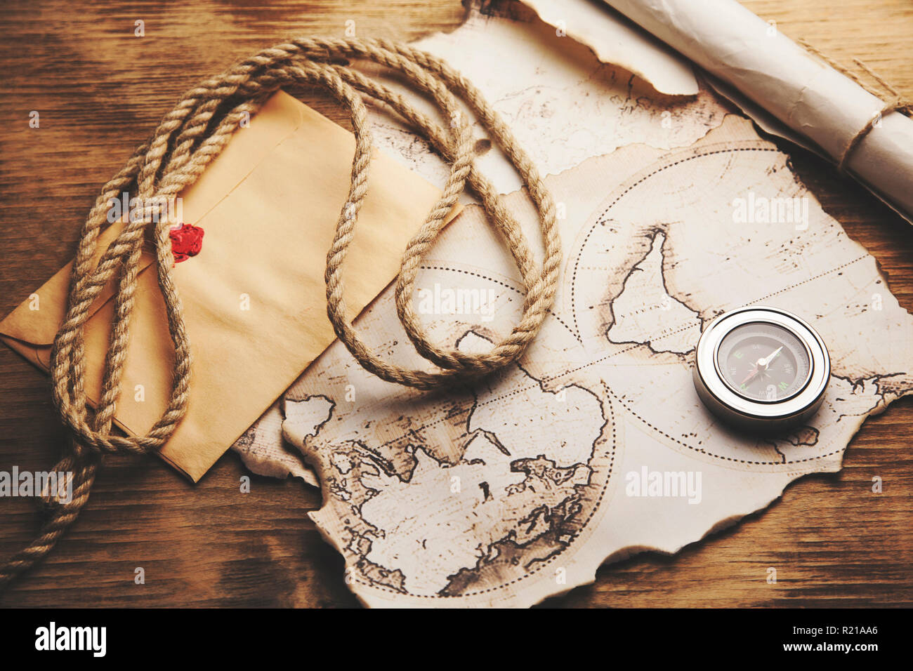 Compass and map on a wooden background Stock Photo - Alamy