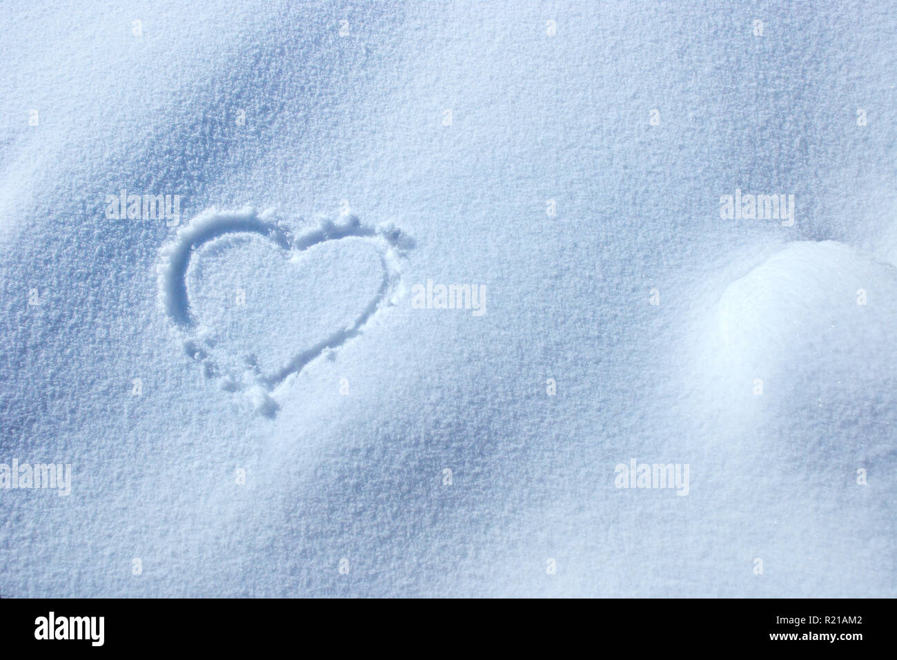 Heart symbol written in the snow, love and Happy Valentine's day ...