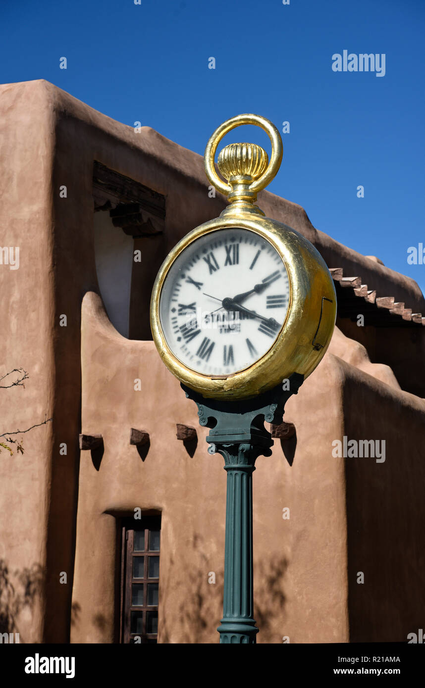 A vintage street clock, or post clock, in front of the New Mexico ...