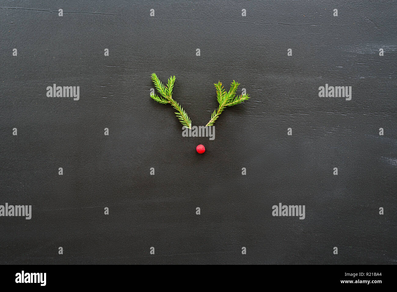 Christmas deer from tree branches and berry on blackboard Stock Photo ...