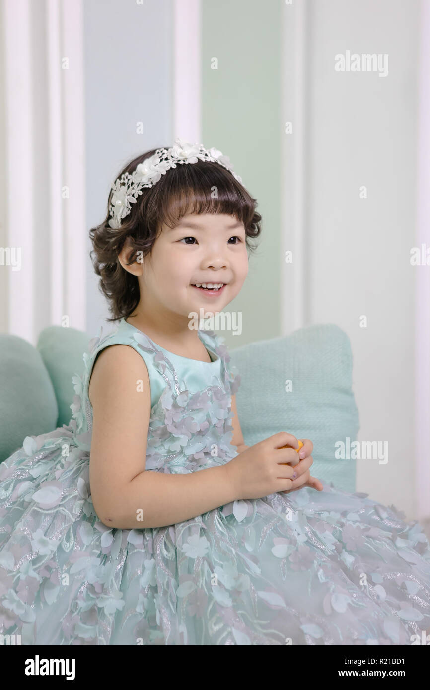 Little pretty Asian girl dressing as princess laughing portrait ...