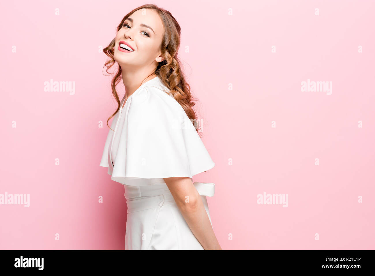 The young woman's portrait with happy emotions on pink background Stock ...
