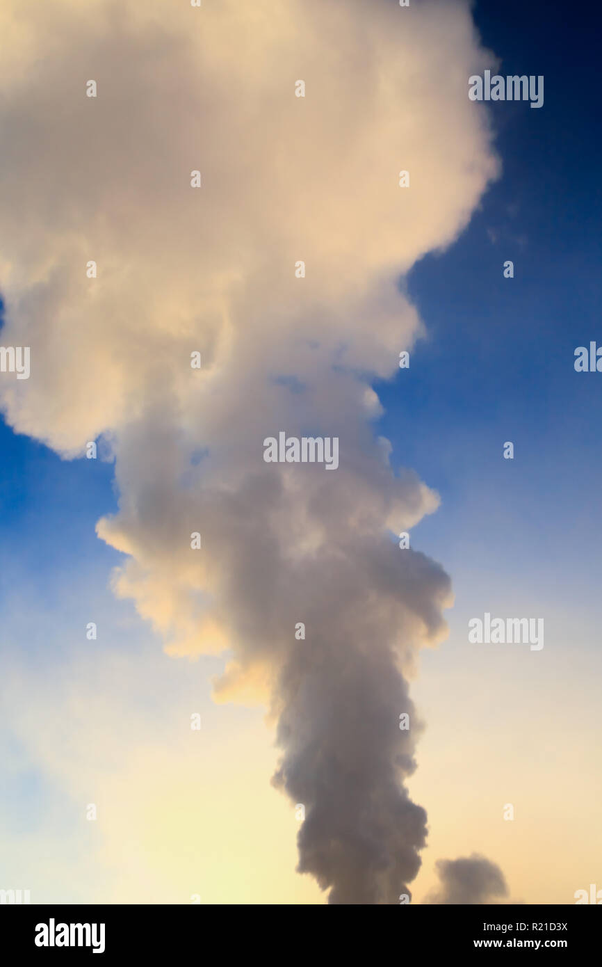Smoke from factory pipes against blue sky. Concept of oil and gas ...