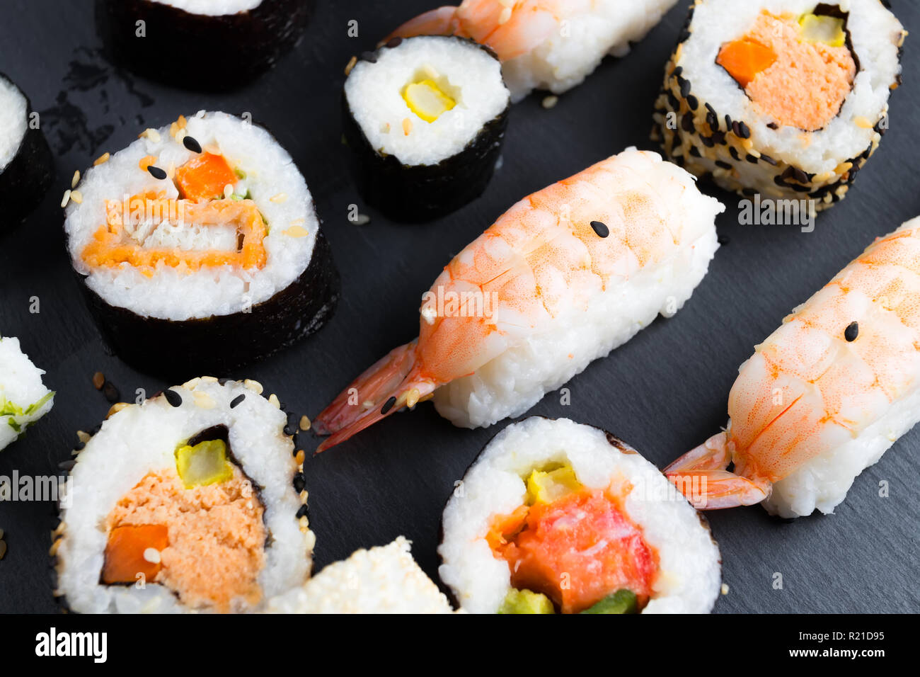 Japanese sushi on black kitchen slate plate. Typical asian cuisine ...