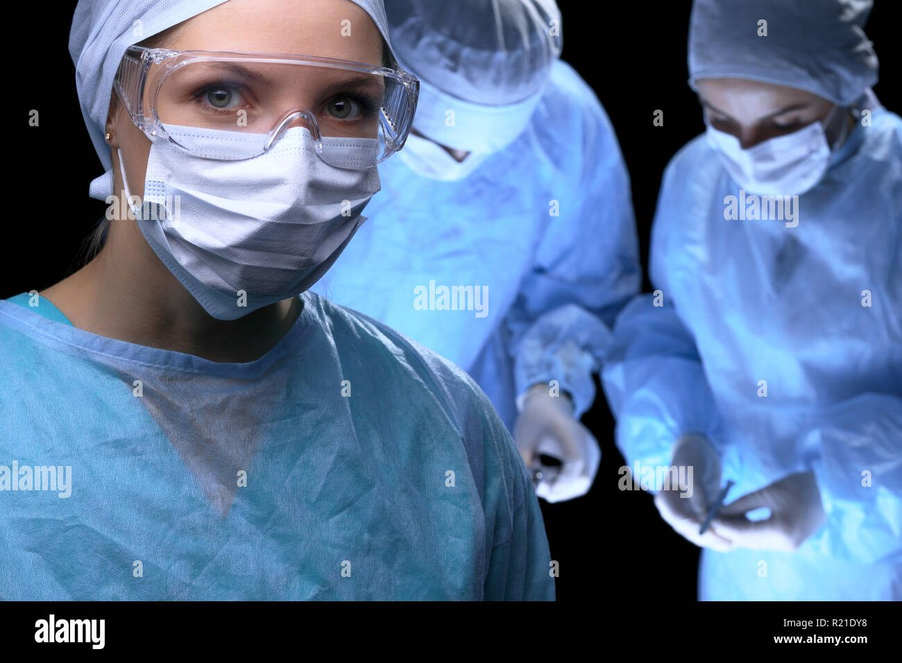 Medical team performing operation. Focus at female doctor. Medicine and ...