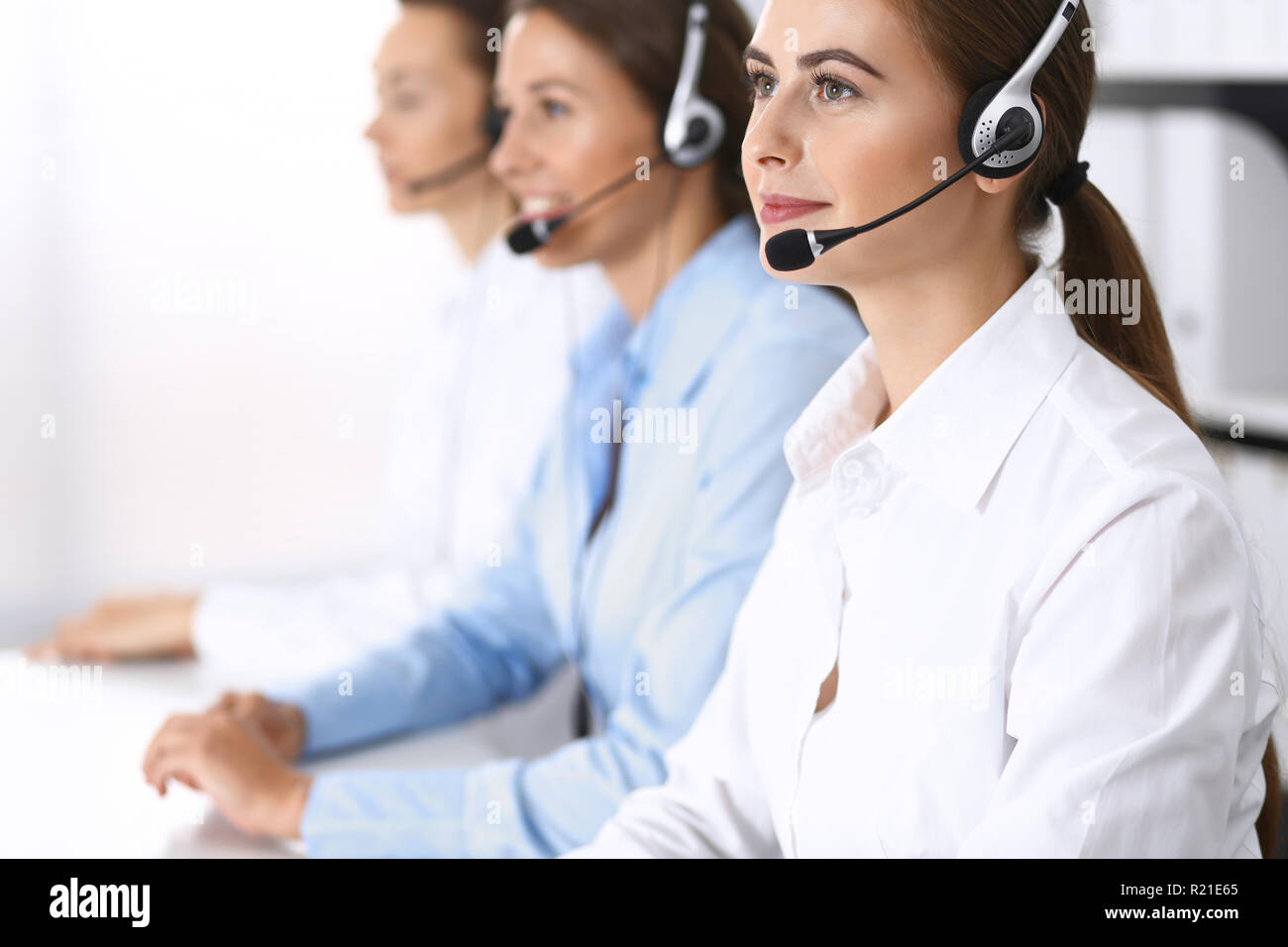 Call center. Group of operators at work. Focus at beautiful business ...