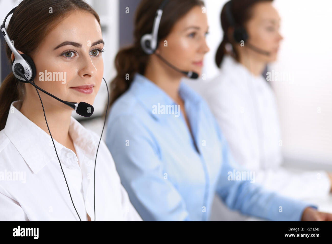 Call center. Group of operators at work. Focus at beautiful business ...